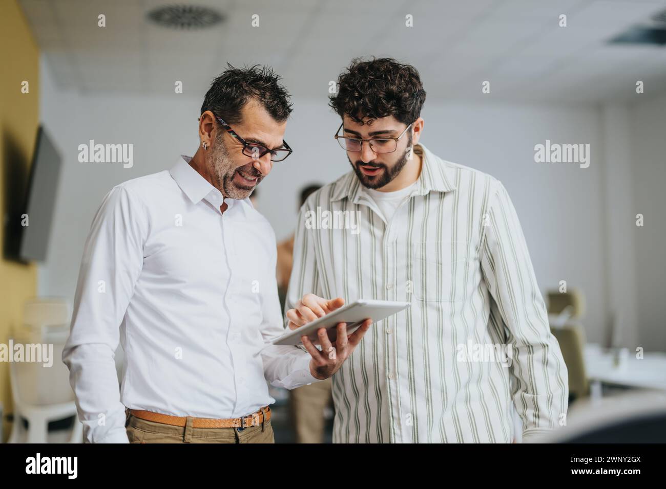 Cross generational colleagues collaborating on new project and ...