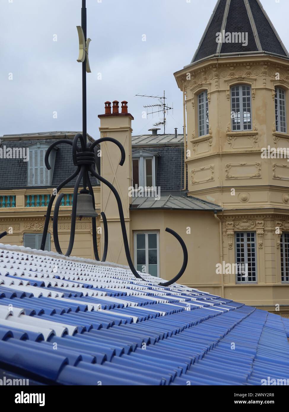Blue & white tiles on the roof and a metal cross with a bell adorn the ...