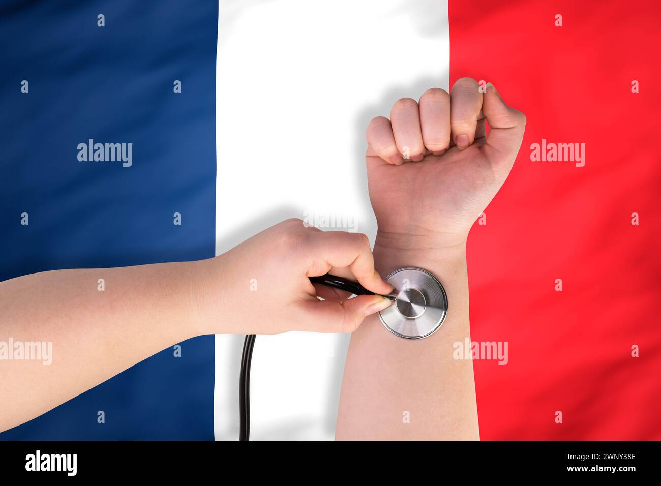 The head of a medical stethoscope on the wrist (close-up) against the ...