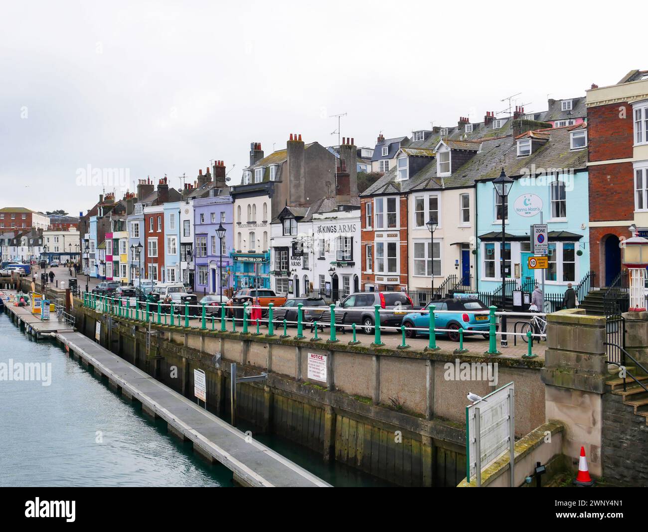 Weymouth Harbour in Dorset, England with old buildings along Trinity ...