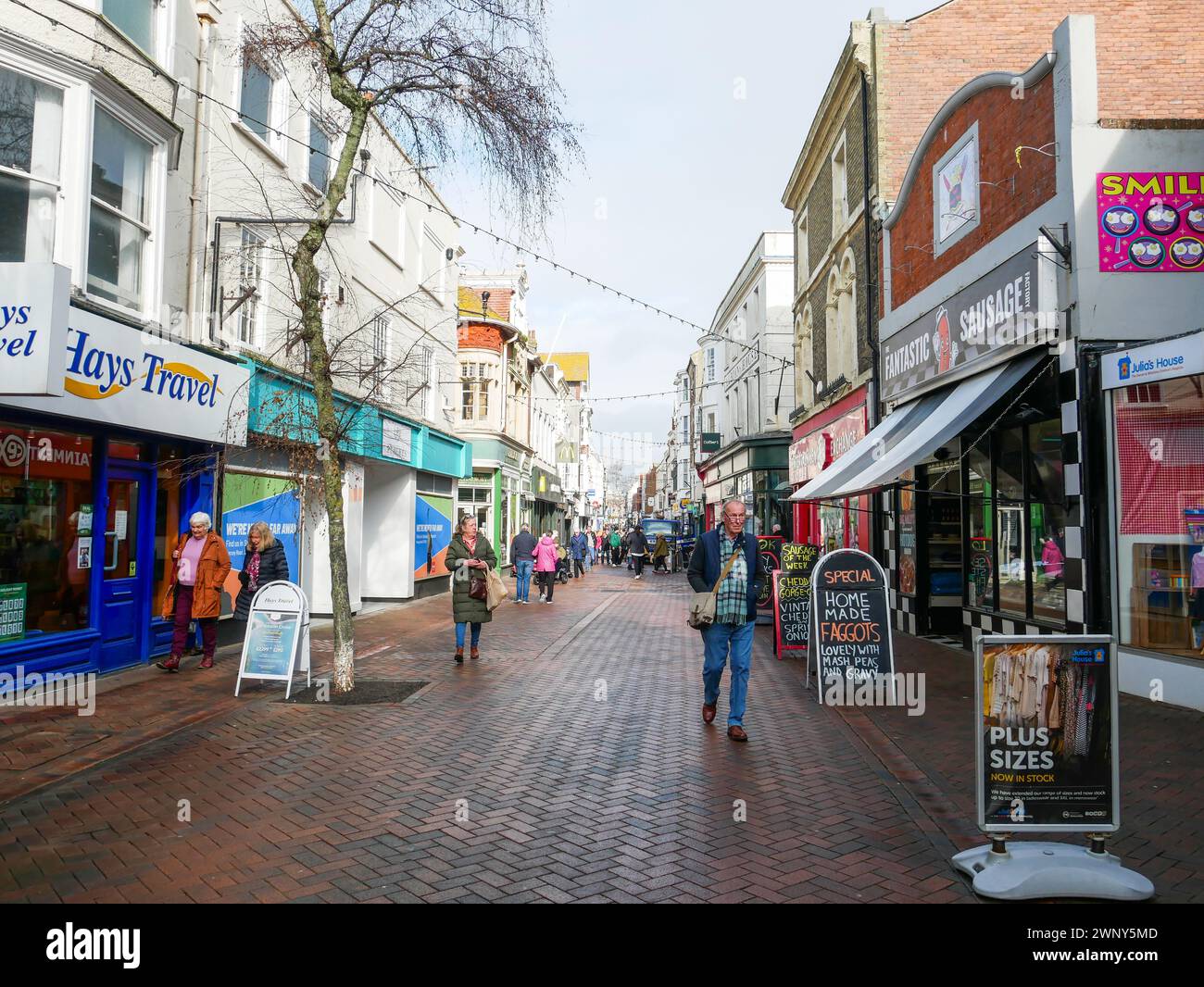 St. Mary Street in Weymouth old town with many shops and pedestrians ...