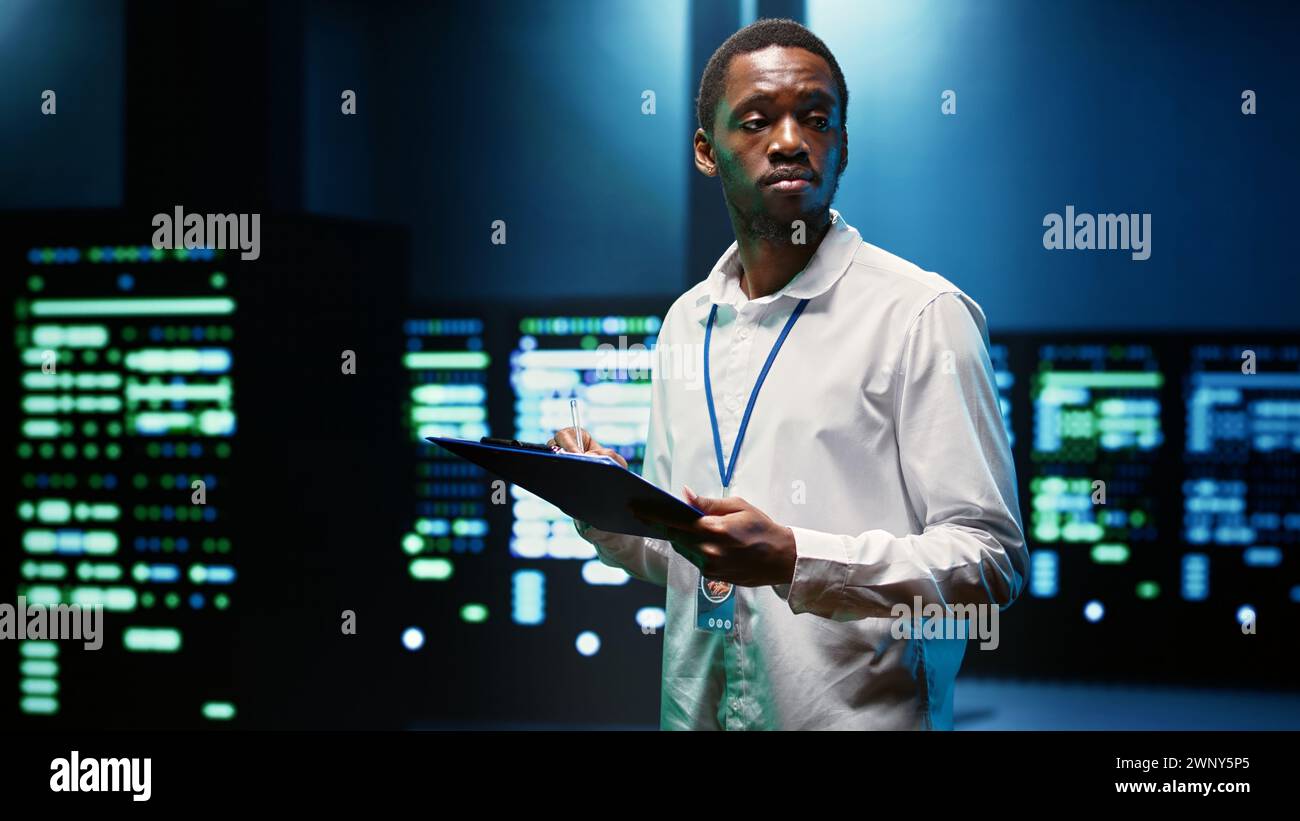 Computer scientist checking server racks performing data backups and providing centralized ...
