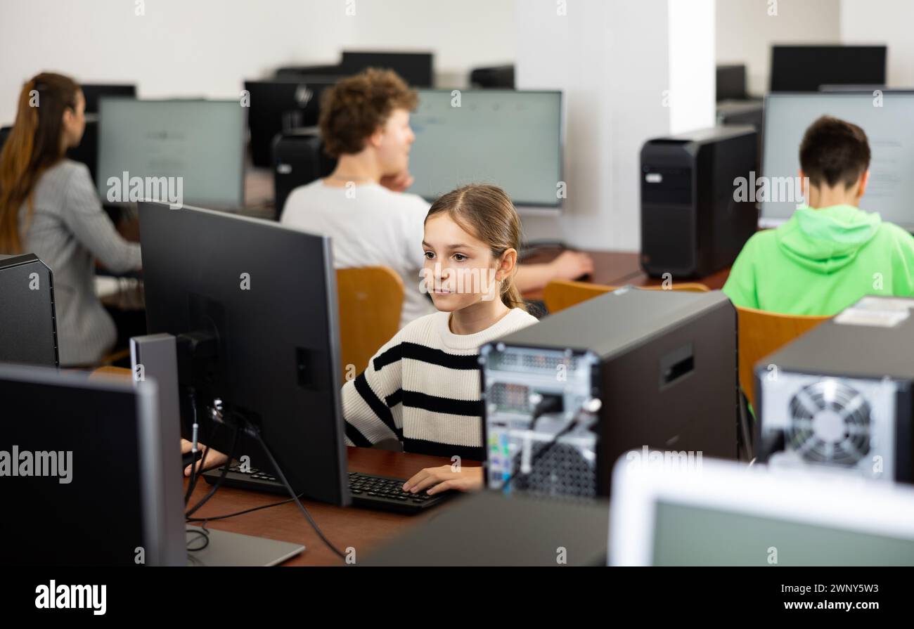 Schoolgirl using PC during computer science lesson Stock Photo - Alamy