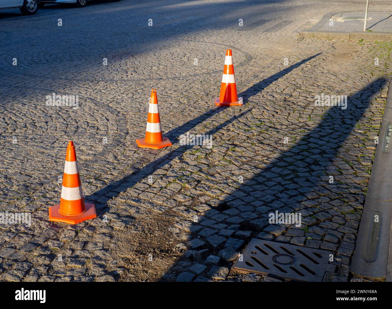 Traffic cones on paving stones. Traffic regulation. Parking. Orange ...