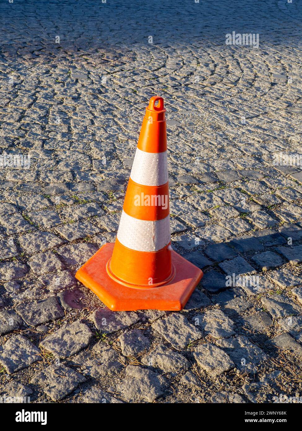 Traffic cones on paving stones. Traffic regulation. Parking. Orange ...