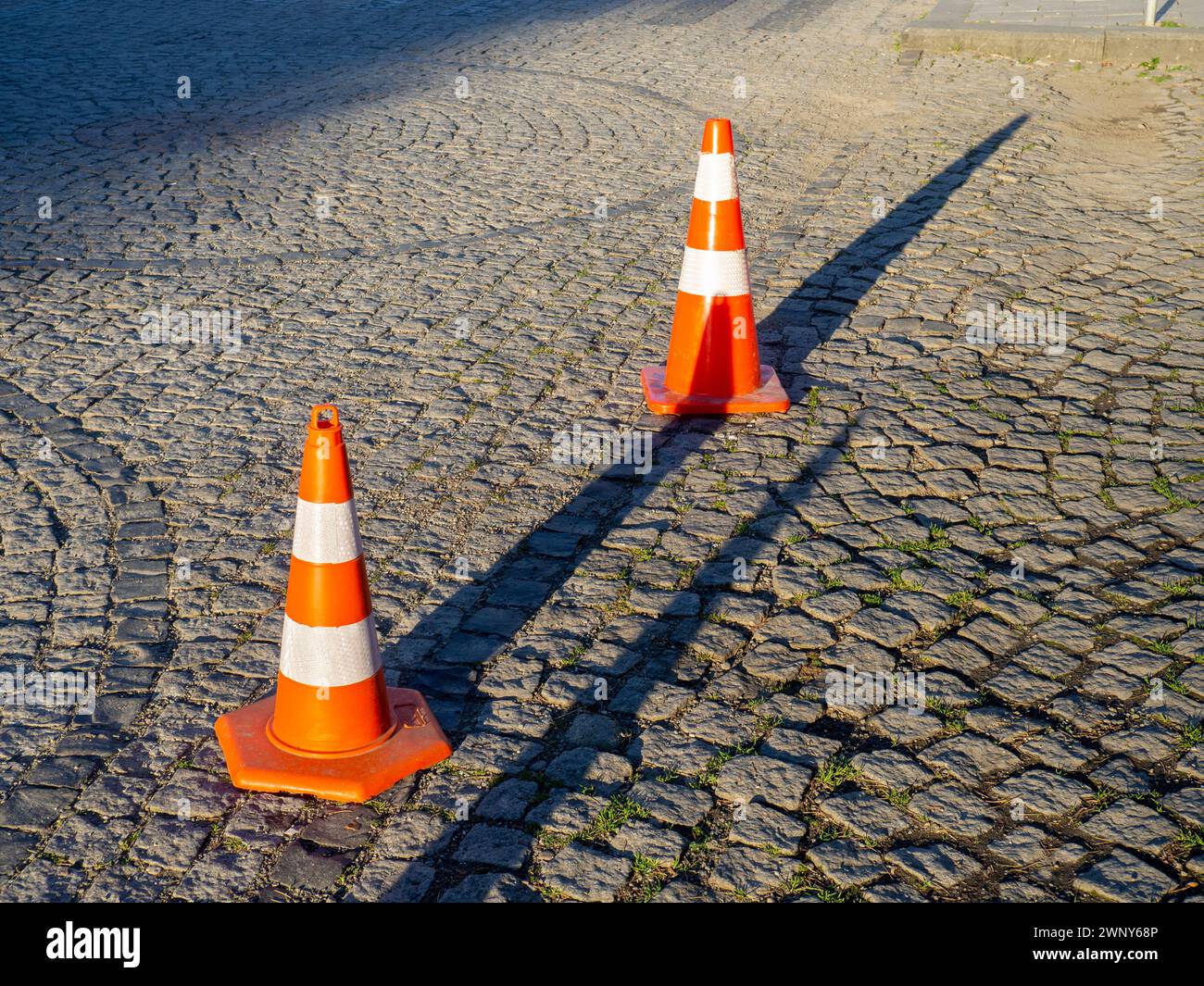 Traffic cones on paving stones. Traffic regulation. Parking. Orange ...