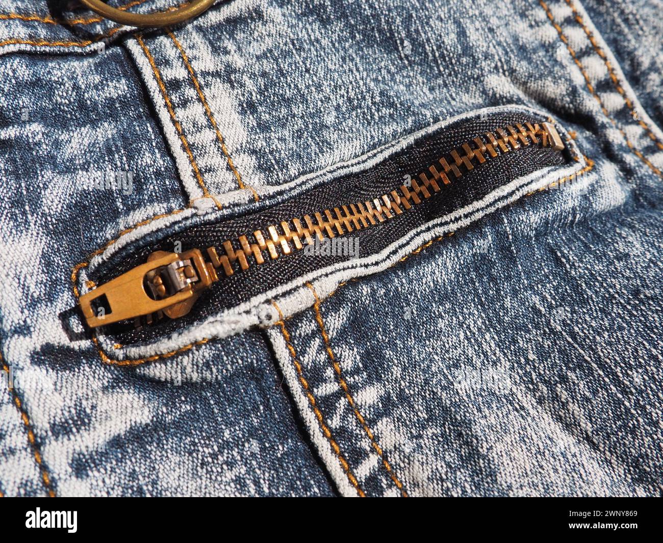 Close-up denim with seams and locks. Heavily shabby worn jeans. Metal ...