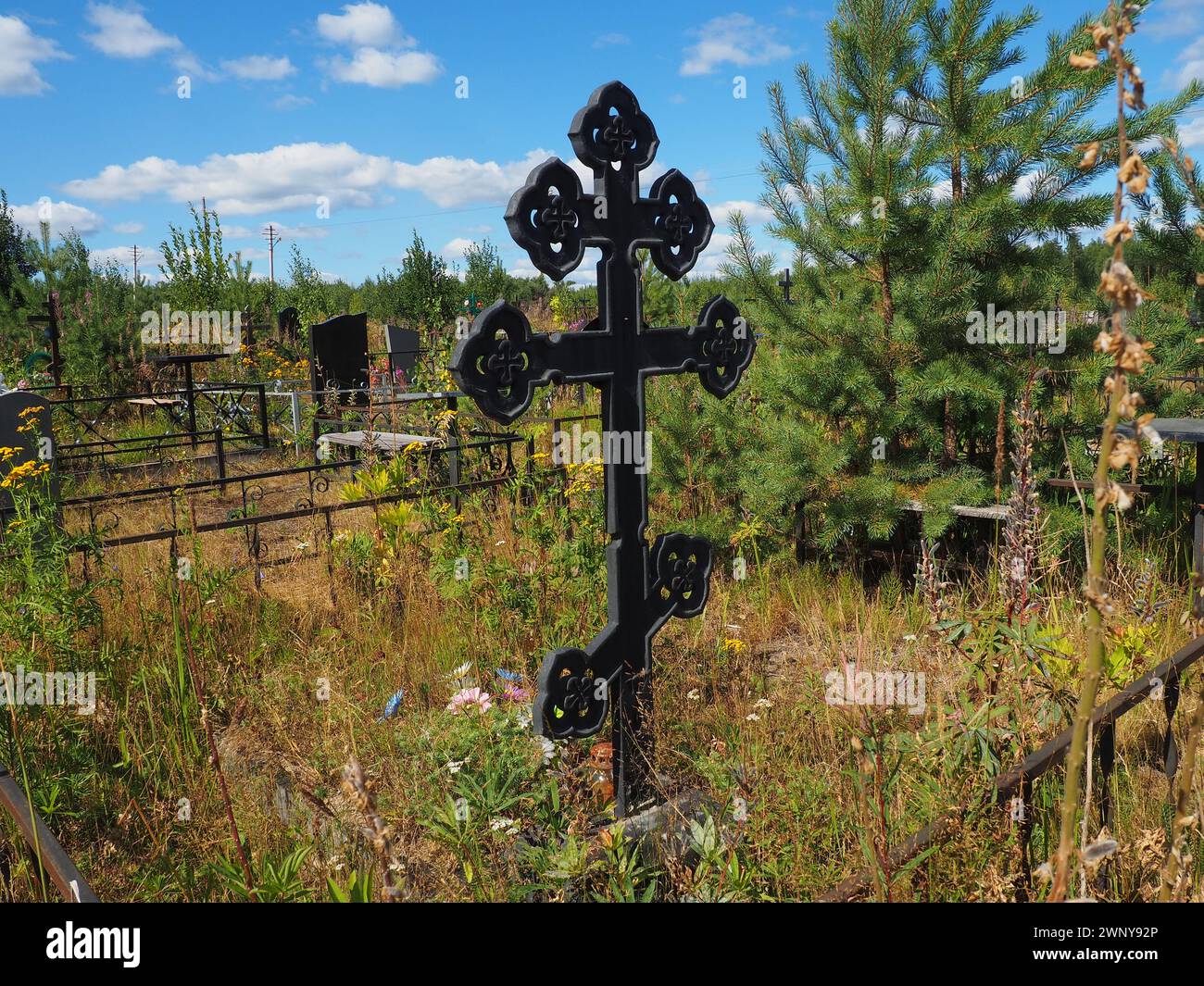 Metal cross on the grave. Monument in the form of a cross in the ...