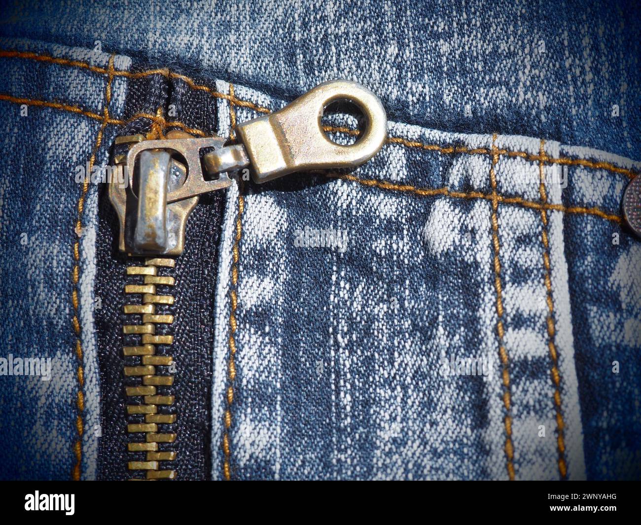 Close-up denim with seams and locks. Heavily shabby worn jeans. Metal ...