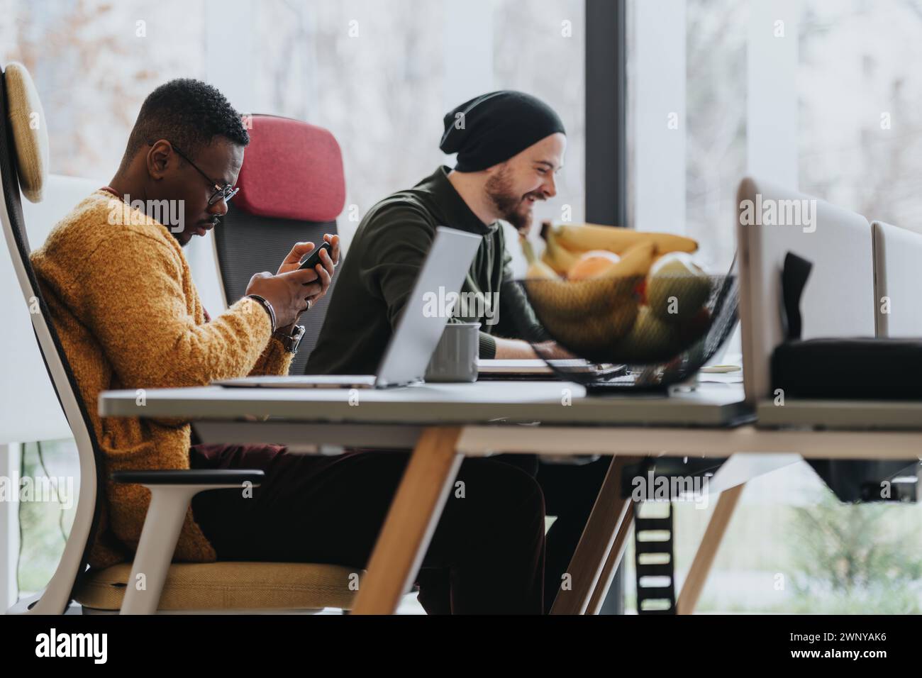 Diverse colleagues working and using smart phones in a modern office ...
