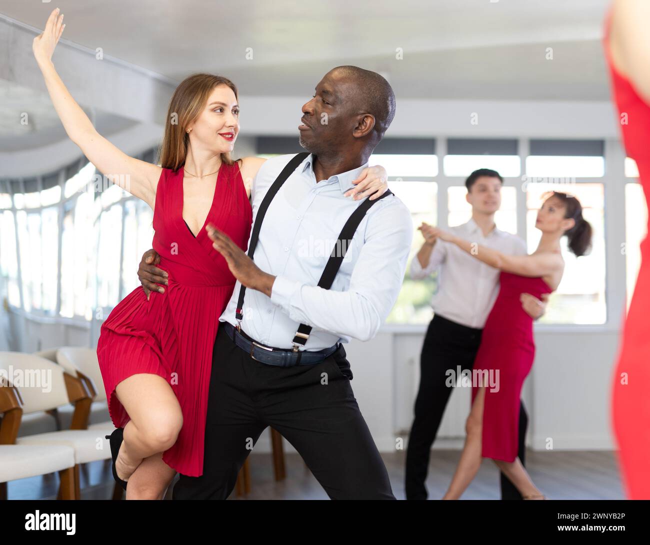 African man and woman dancing tango in couple during lesson at studio Stock Photo - Alamy