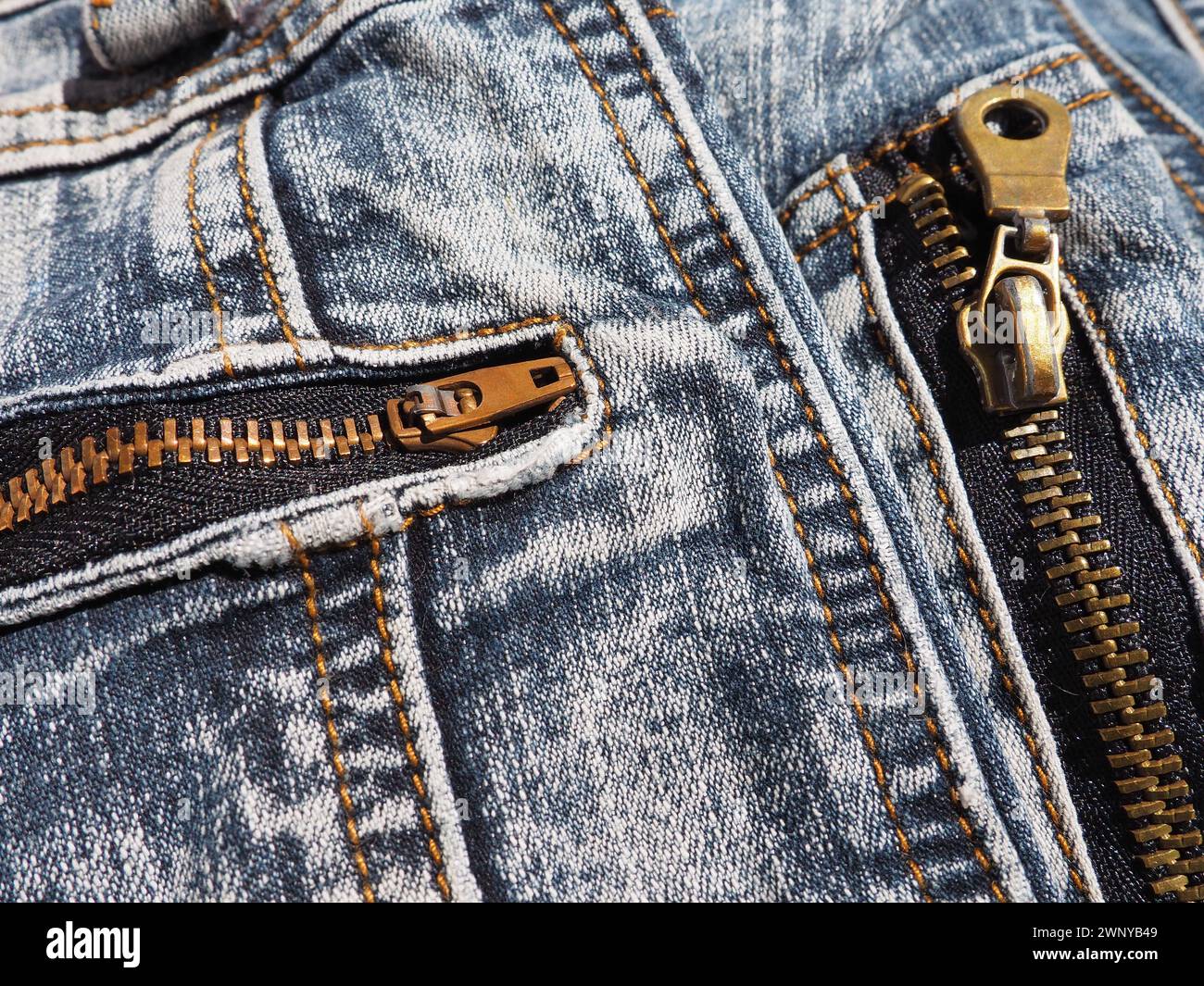 Close-up denim with seams and locks. Heavily shabby worn jeans. Metal ...