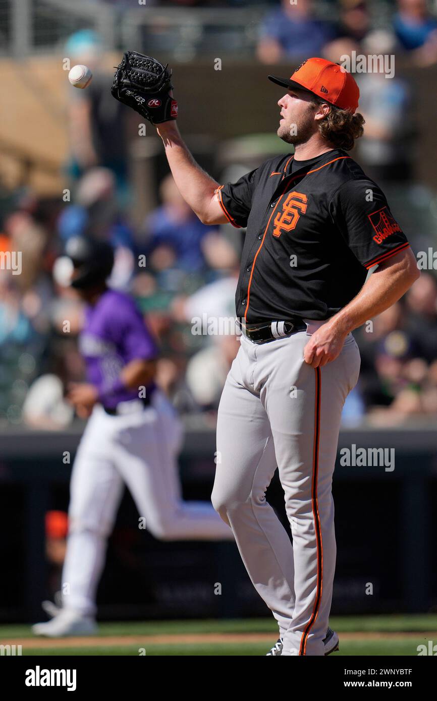 San Francisco Giants relief pitcher Erik Miller, right, gets a new baseball after giving up a ...