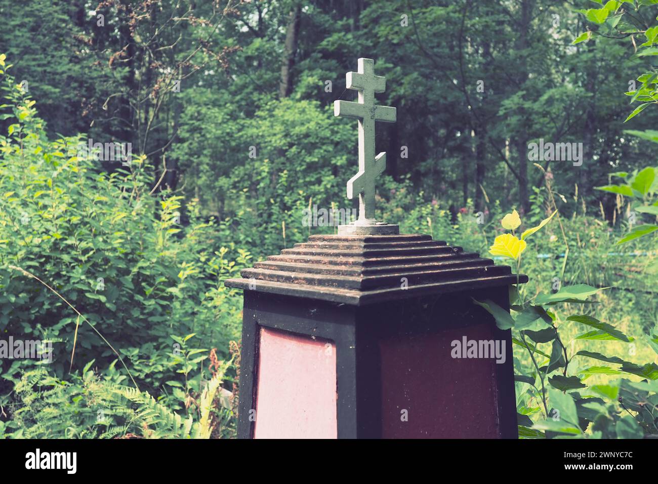 Metal cross on the grave. Monument in the form of a cross in the ...