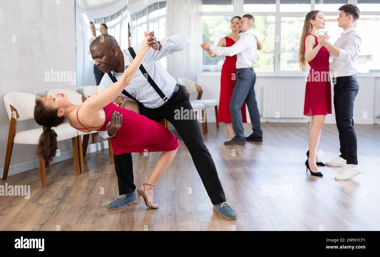 African man and woman dancing tango in couple during lesson at studio Stock Photo - Alamy