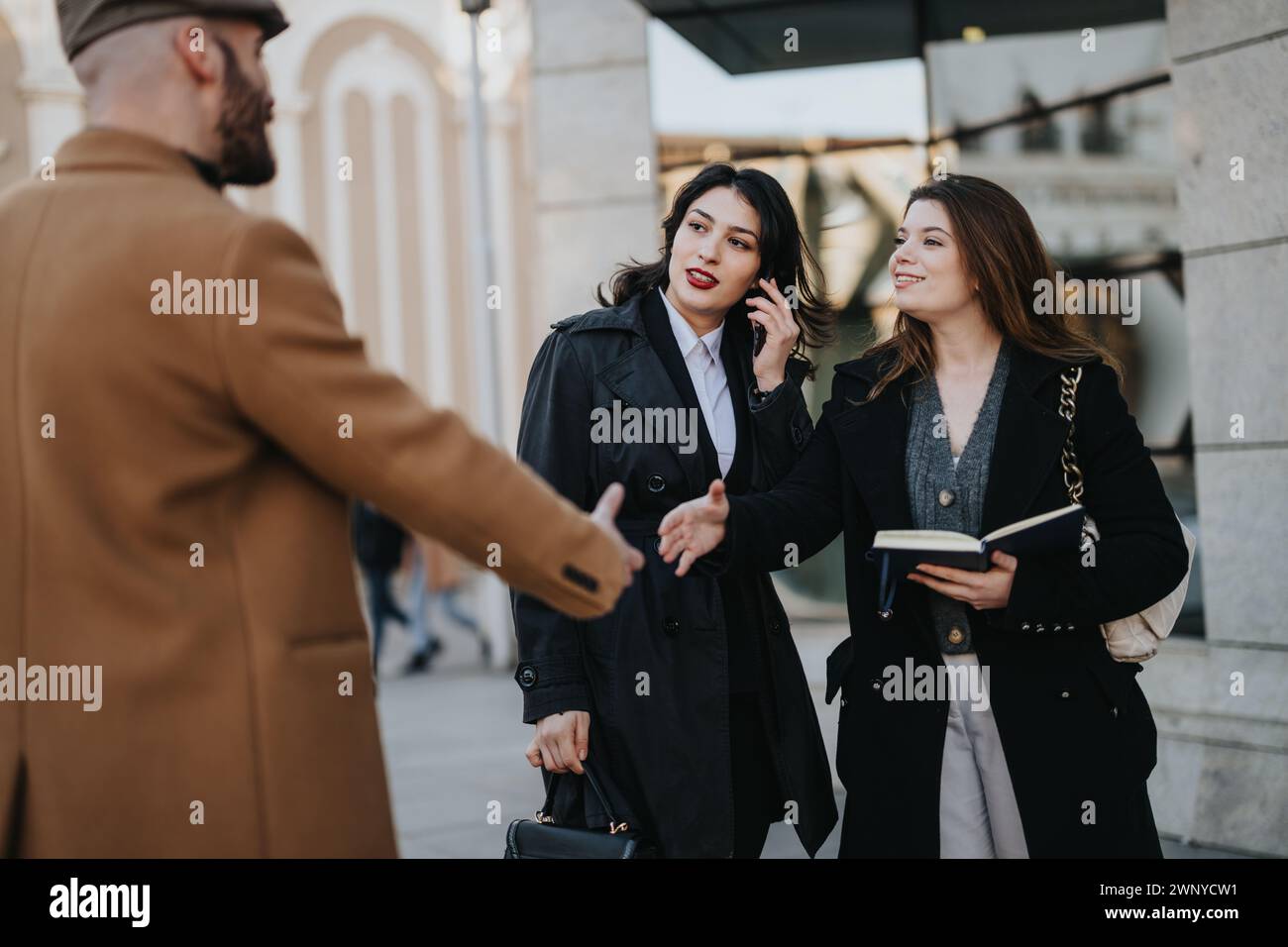 Business meeting initiation. Business teammates handshaking in urban ...