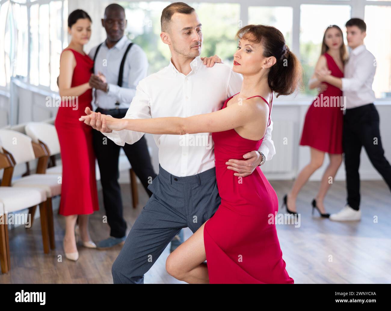 Elegant couple performing expressive tango in dance studio Stock Photo ...