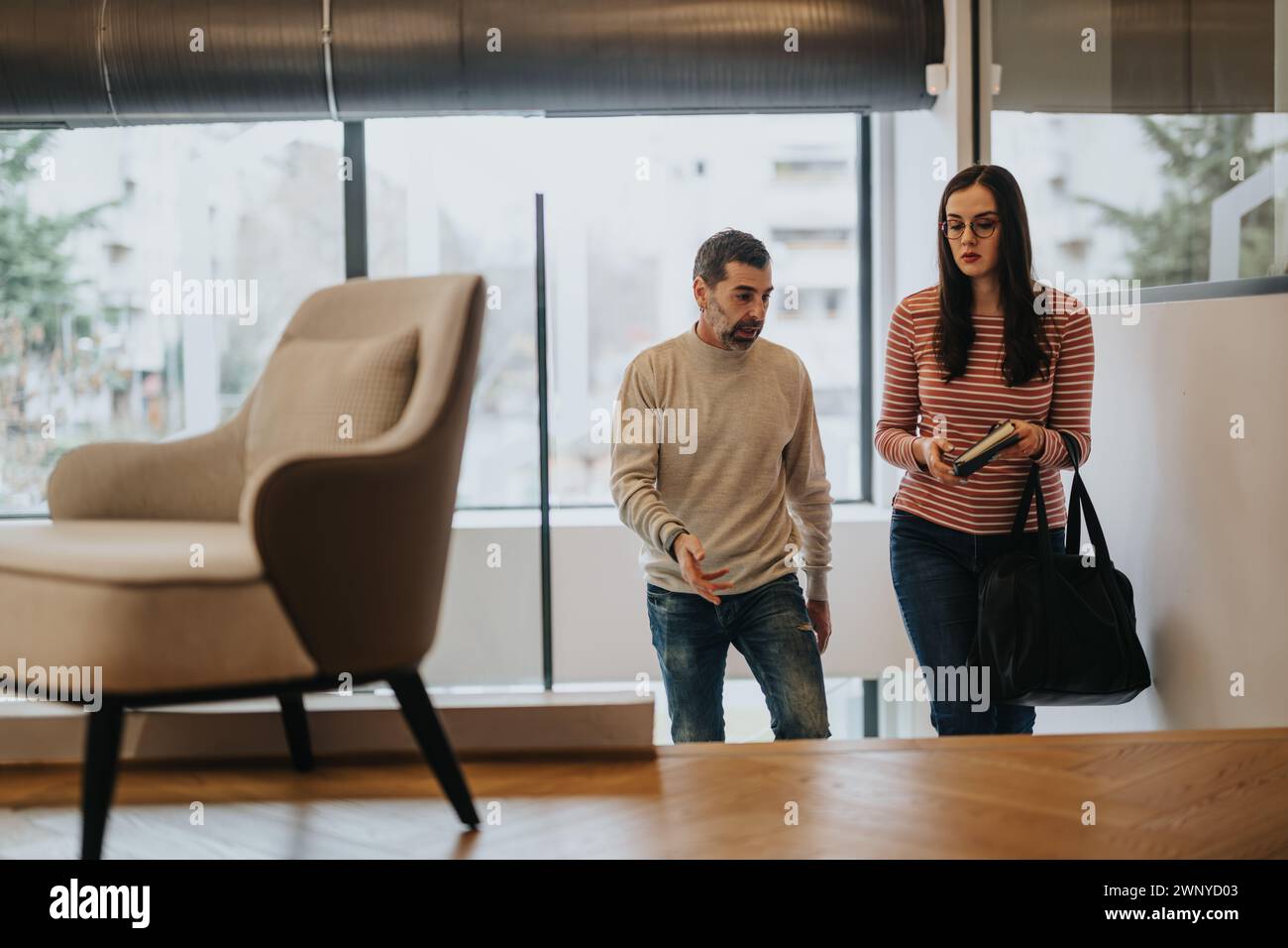 Conversation between colleagues in modern office environment with ...