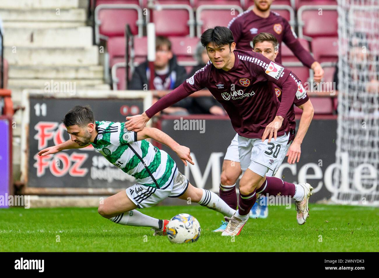 Kyosuke Tagawa of Hearts, Japanese player in action against Greg Taylor ...