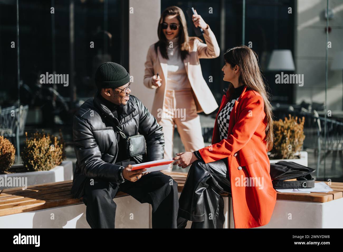 Diverse colleagues sitting on bench hi-res stock photography and images ...