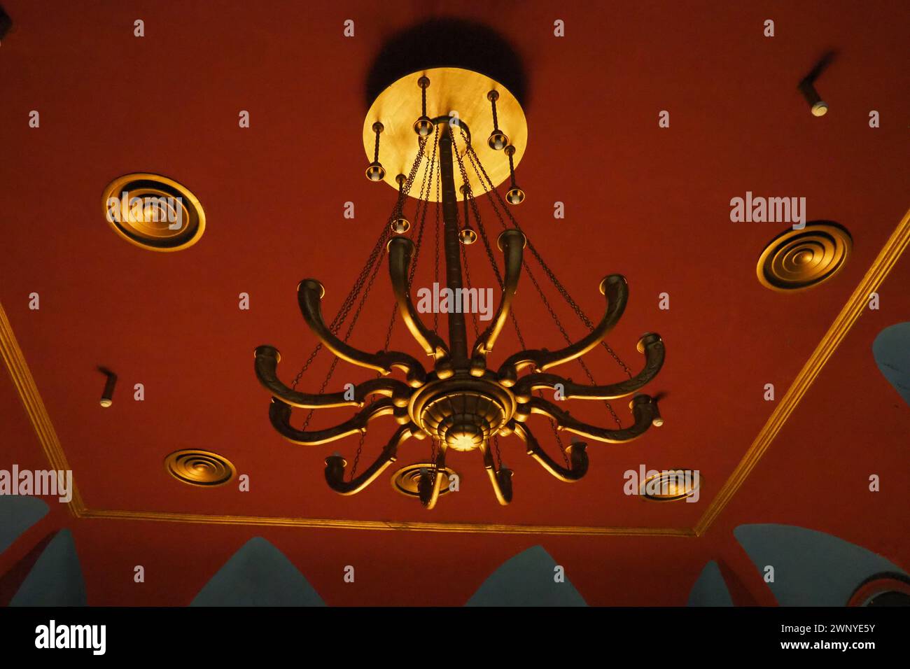 Theatrical golden chandelier under the ceiling of the theater hall ...