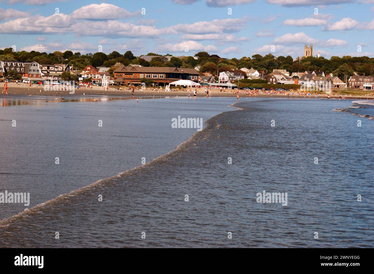 The waters recede from the beach on a sunny day in Newport Rhode Island ...
