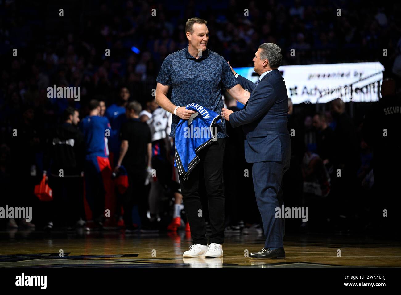 Former Orlando Magic forward Pat Garrity, left, is honored by Magic CEO ...