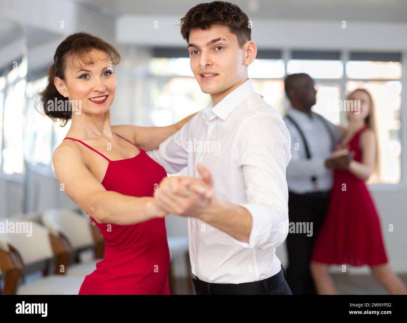 Young guy and adult woman dance tango Stock Photo - Alamy