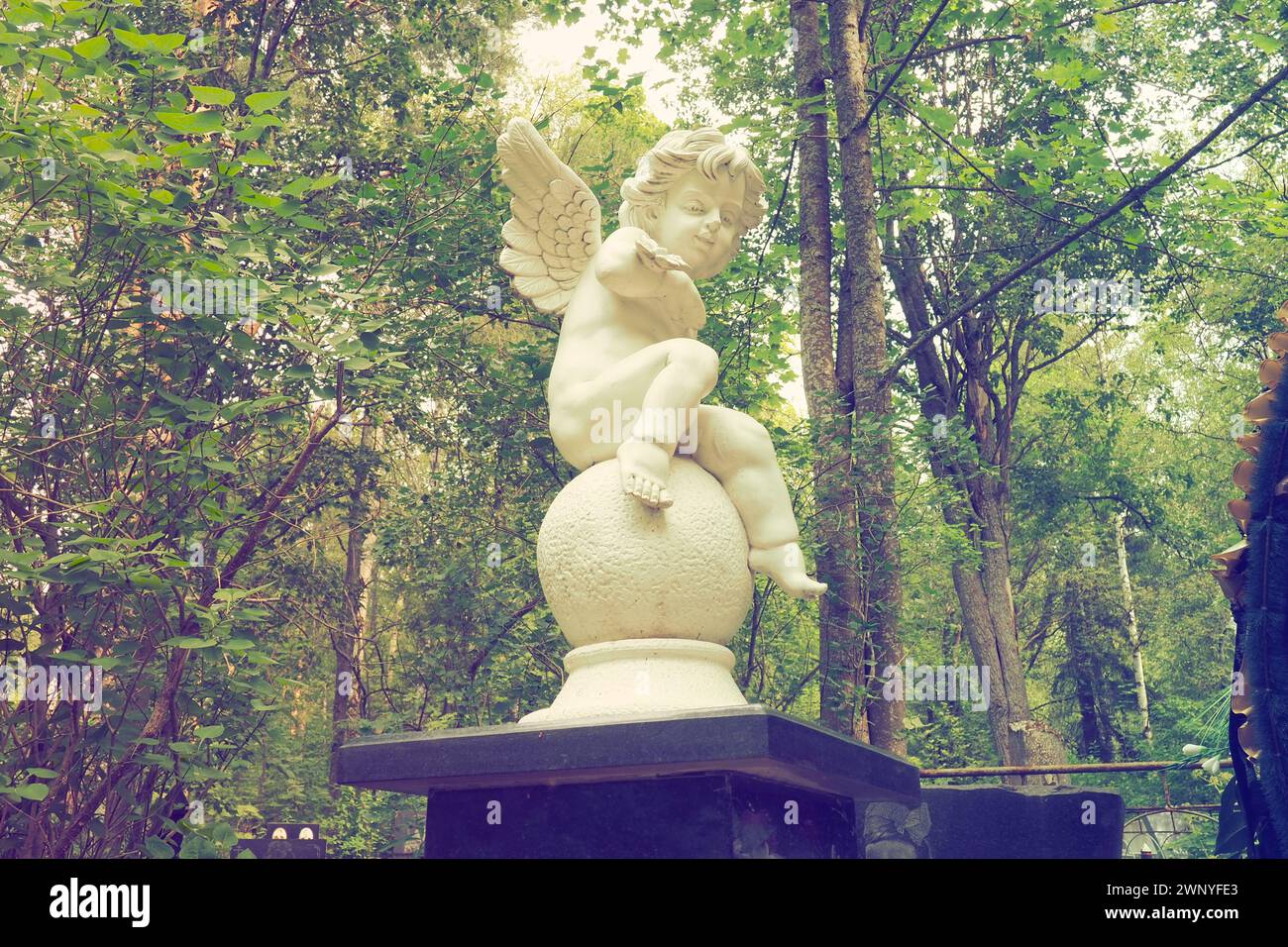 Angel in the cemetery monument at the grave of a child sculpture in the ...
