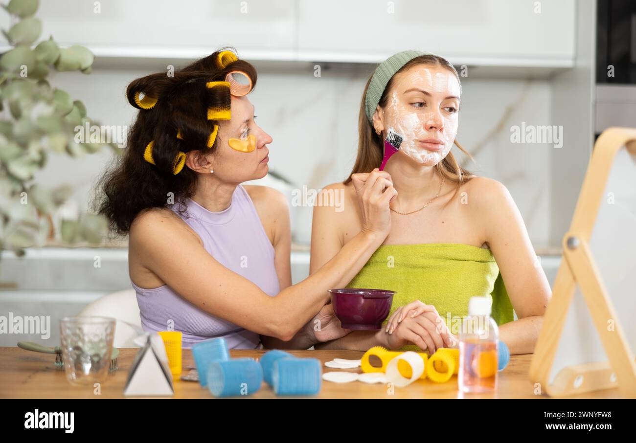Female friends enjoying skincare ritual during home spa day Stock Photo ...