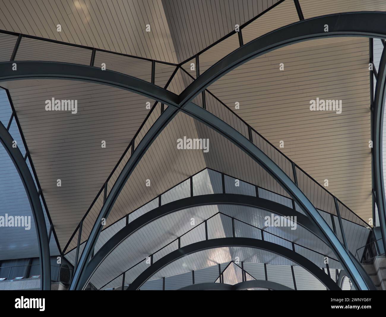 Arches and arches of the station. Metal structures under the roof of a ...