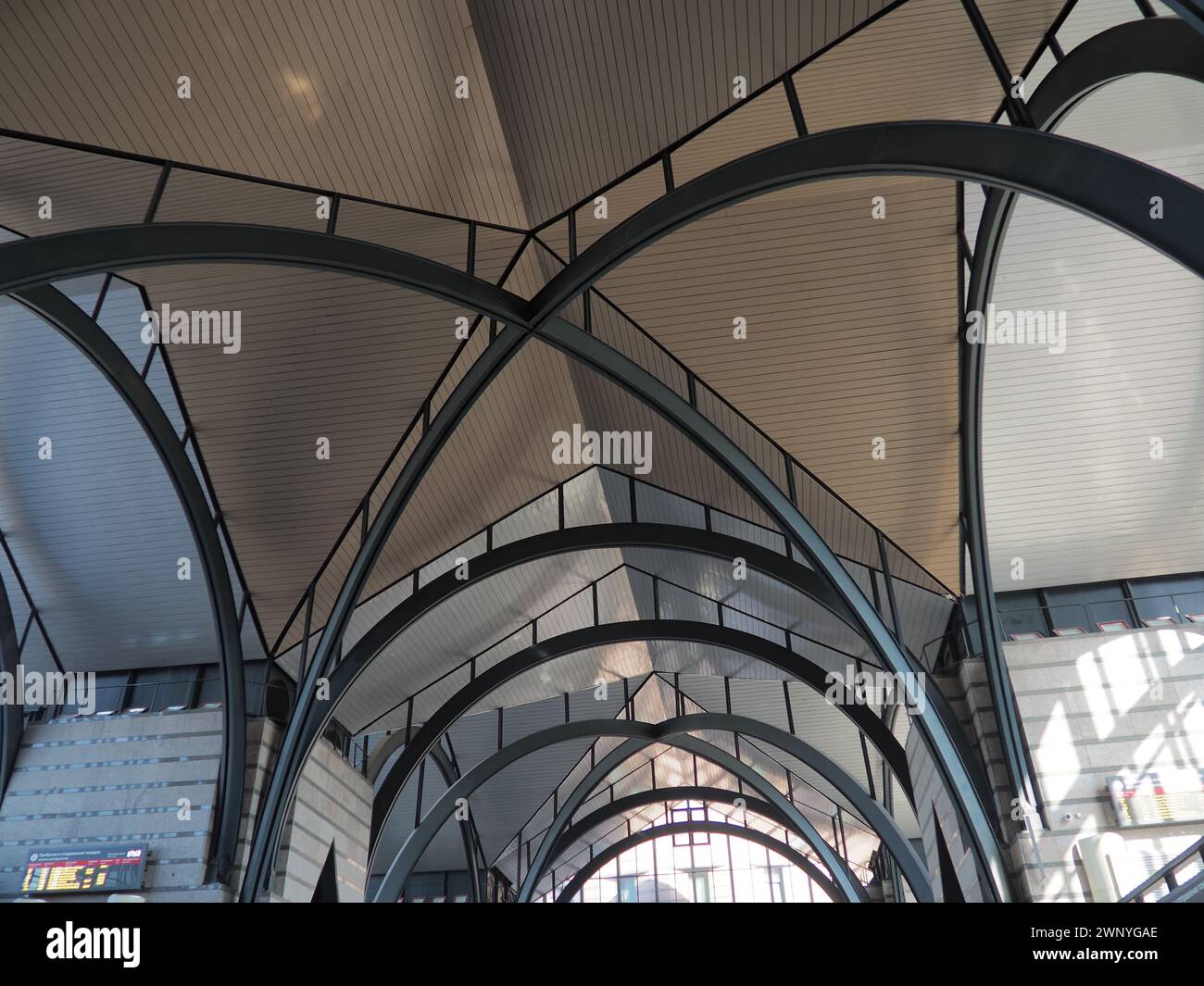 Arches and arches of the station. Metal structures under the roof of a ...