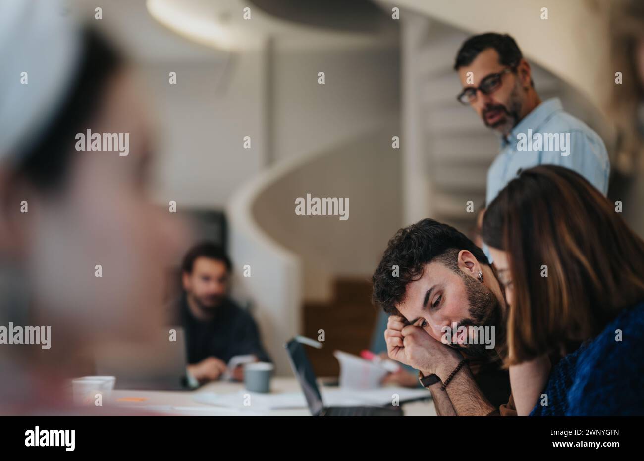 Multi generational business teammates engaged in creative process at ...