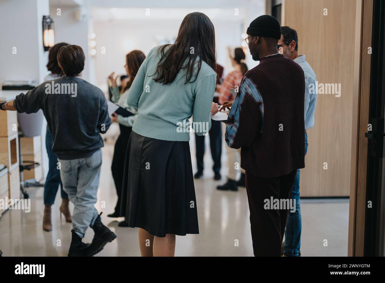 Diverse group of business people queuing at a modern office or event ...