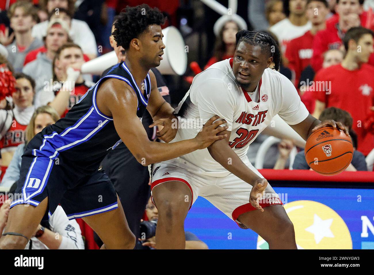 North Carolina State's DJ Burns Jr. (30) tries to drive the ball through Duke's Sean Stewart (13 ...