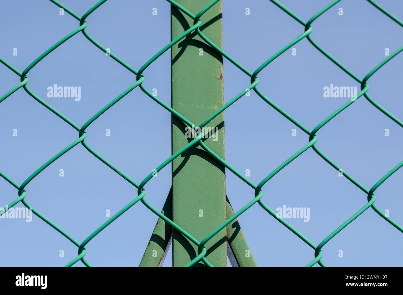 Metal fence made of diamond-shaped steel wire, mesh stretched to ...