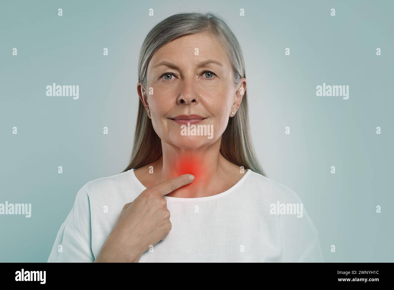 Endocrine system. Woman doing thyroid self examination on light blue ...