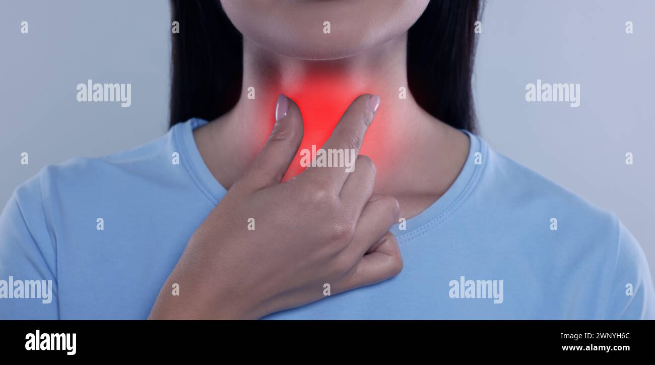 Endocrine system. Woman doing thyroid self examination on grey ...