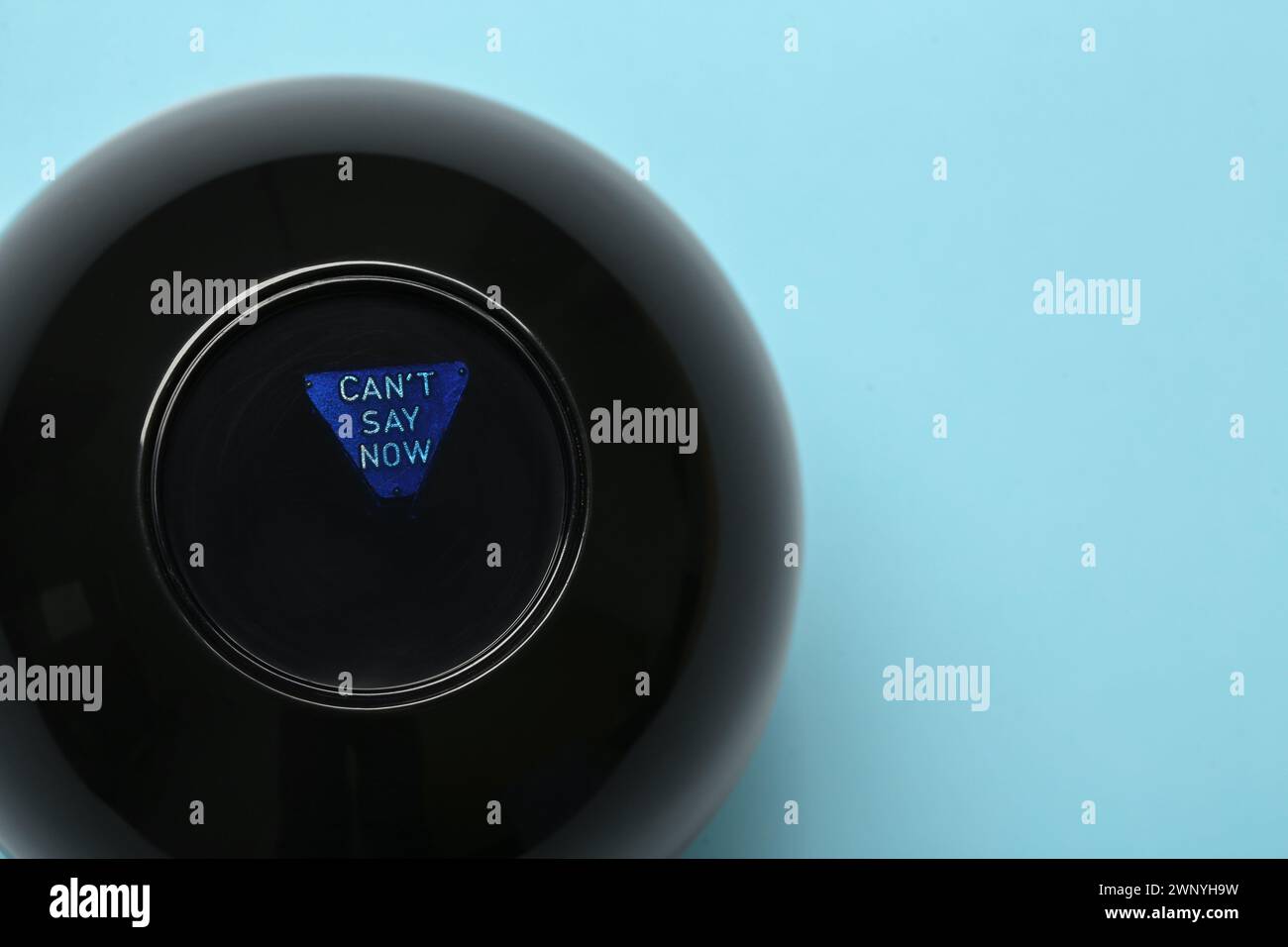 Magic eight ball with prediction Can't Say Now on light blue background ...