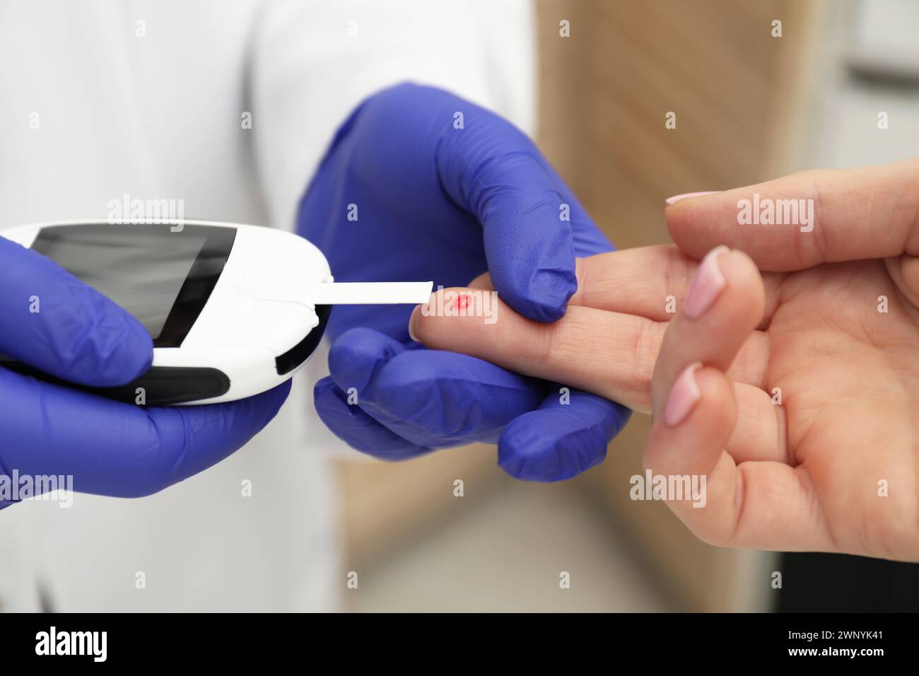 Diabetes. Doctor checking patient's blood sugar level with glucometer ...