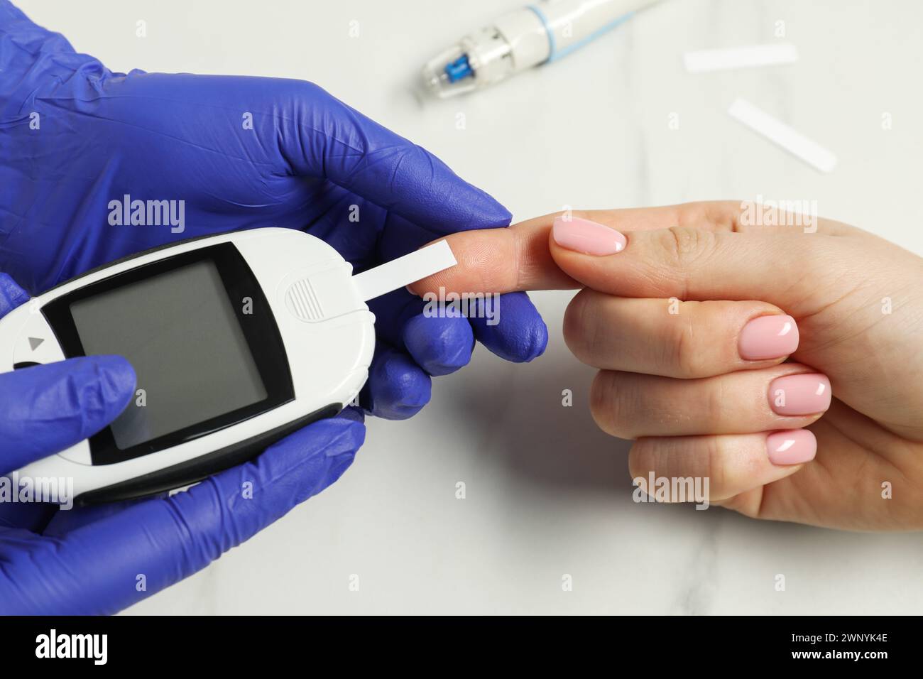 Diabetes. Doctor checking patient's blood sugar level with glucometer ...