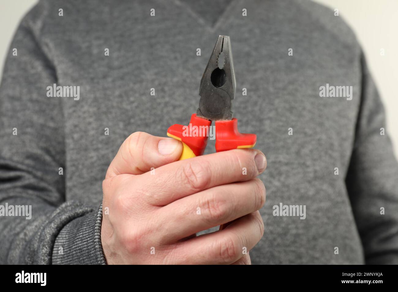 Man with color combination pliers, closeup view Stock Photo - Alamy