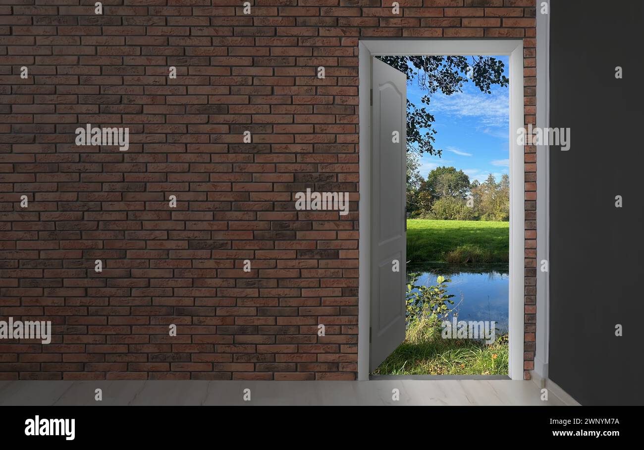 Open door in brick wall inviting to rest in nature Stock Photo - Alamy