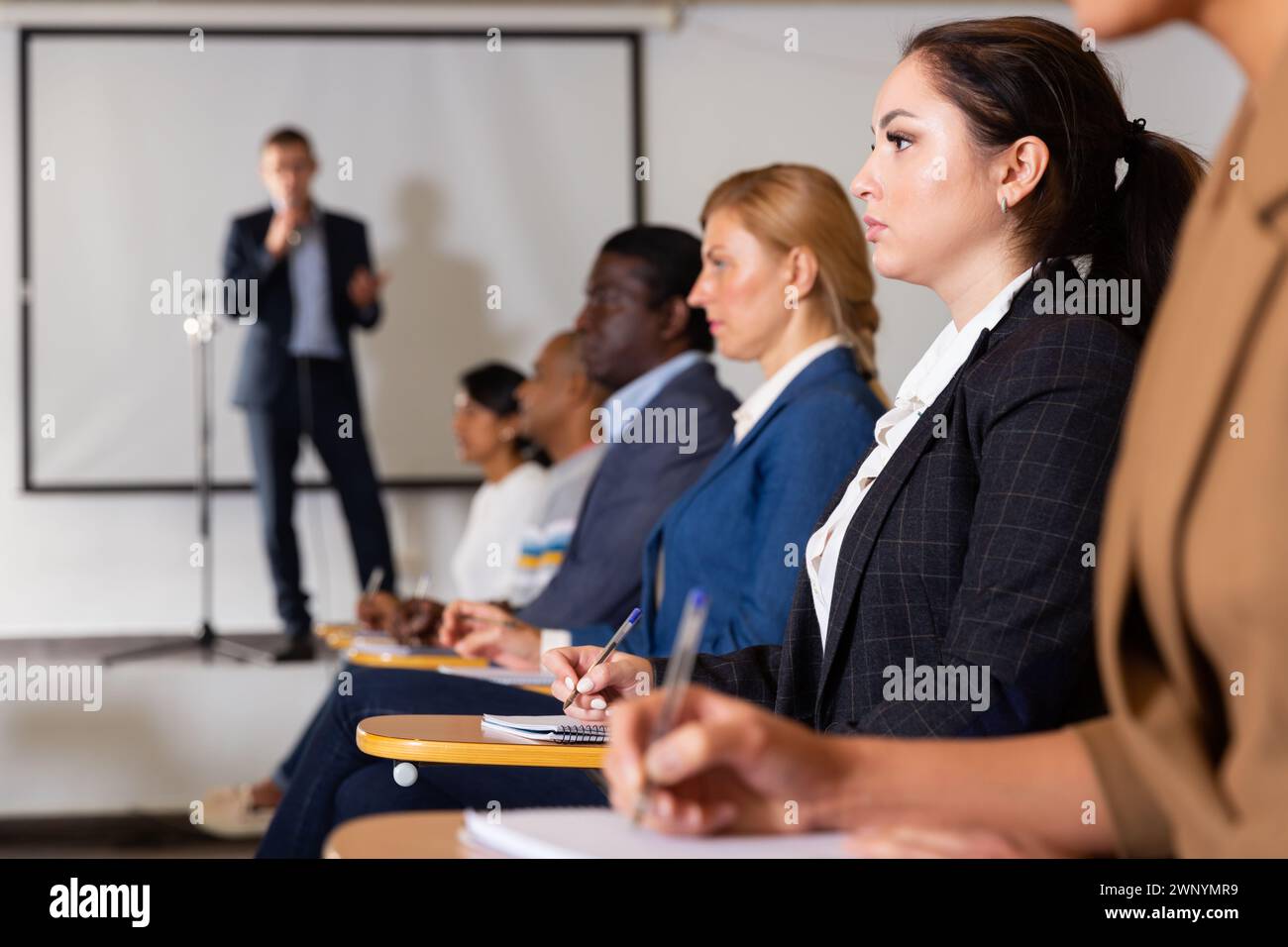 Female entrepreneur sitting in conference room at business training ...