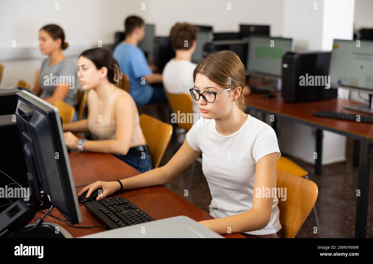Teenage girl learning to use personal computer during lesson Stock ...
