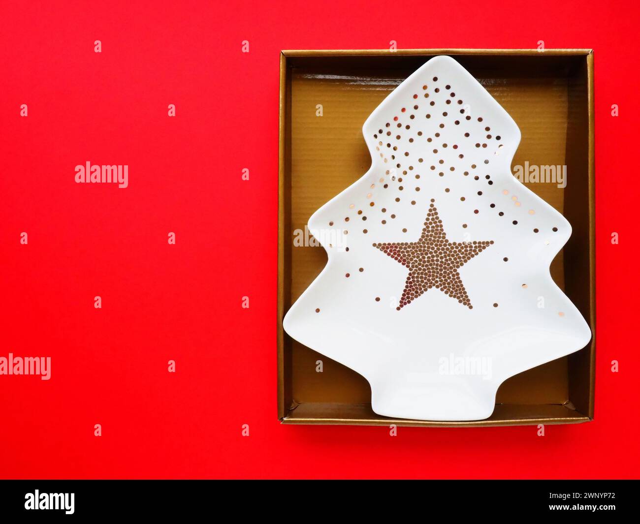 A plate in the shape of a Christmas tree with gold ornaments and a star ...