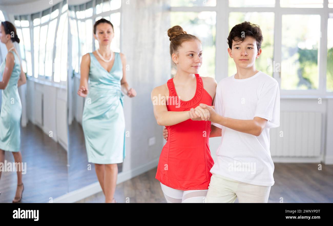 Girl and a boy are having fun learning to dance tango at choreographic ...