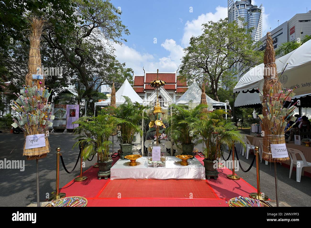 'Money trees' and offering box set up at a Buddhist temple in central ...