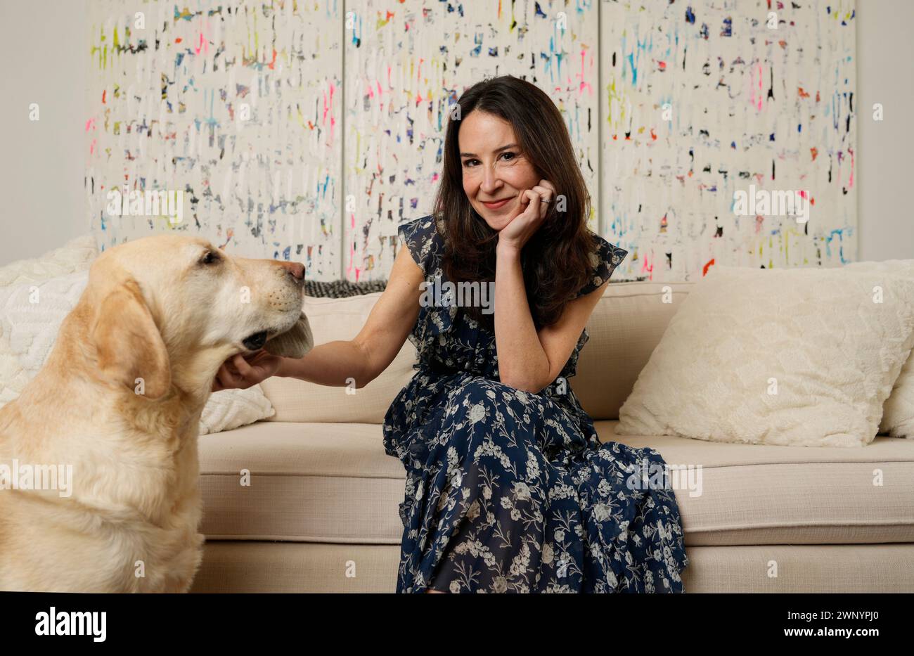 Author Allison Winn Scotch is joined by her dog Mr. Peanut as she poses ...