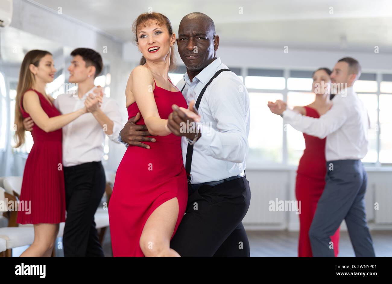 Woman dances incendiary boogie woogie with African man partner during ...